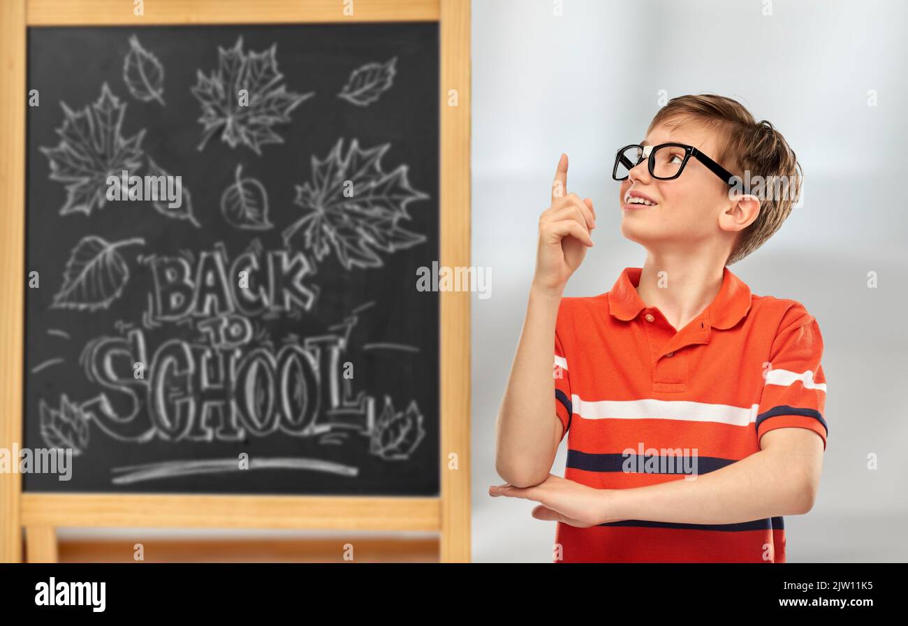 happy student boy in eyeglasses over chalkboard Stock Photo - Alamy