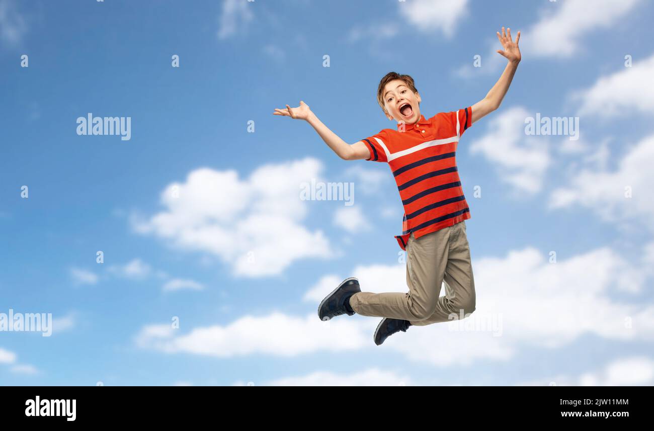 happy smiling young boy jumping over sky Stock Photo - Alamy