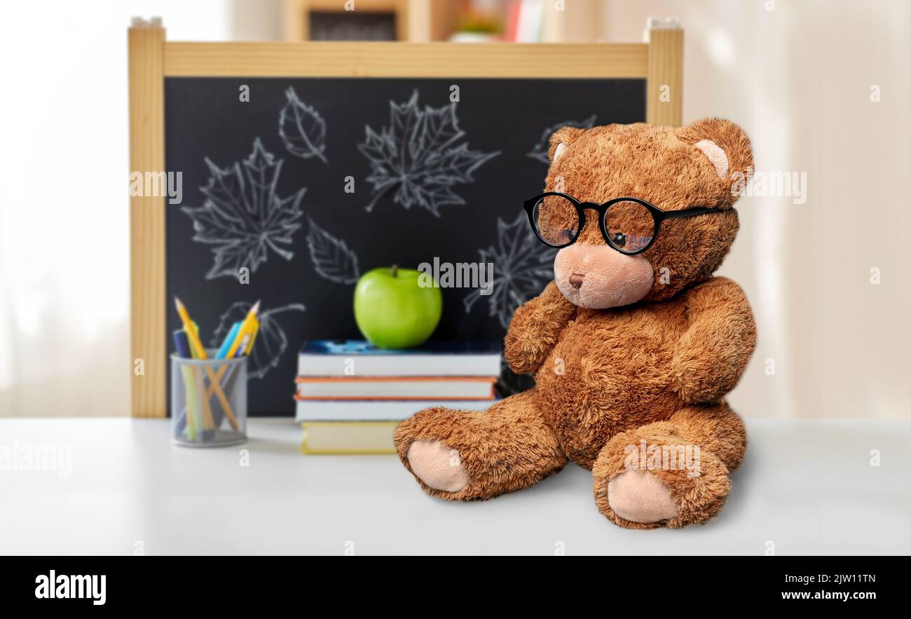 teddy bear in glasses over school chalkboard Stock Photo - Alamy