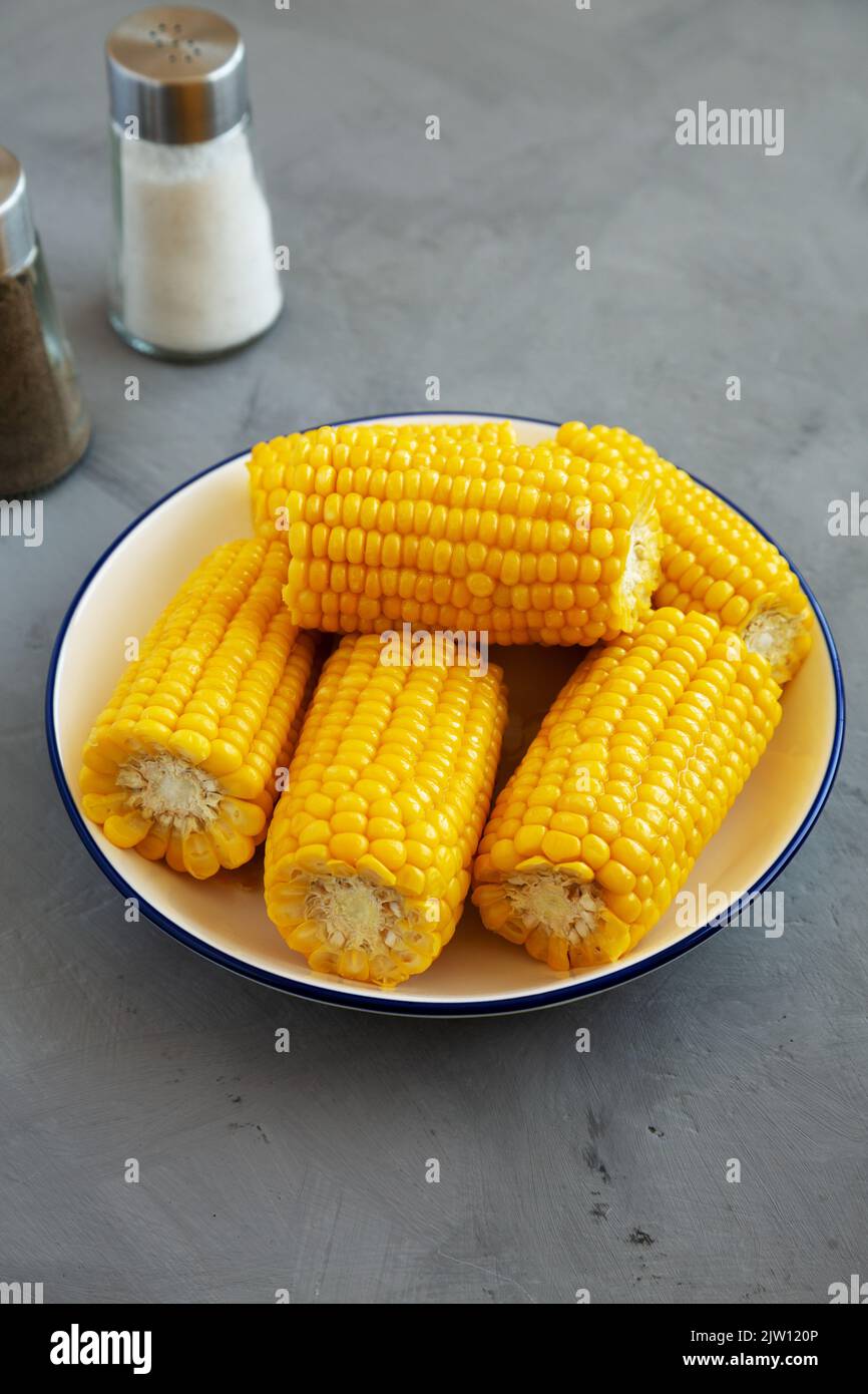 Homemade Steamed Corn on the Cob with Butter on a Plate, side view ...