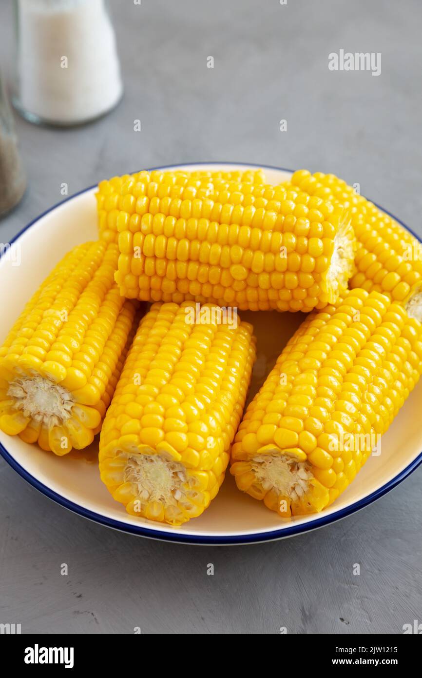 Homemade Steamed Corn on the Cob with Butter on a Plate, side view ...