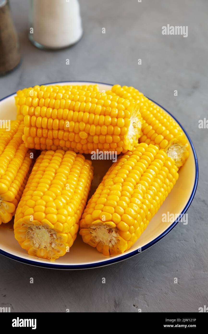 Homemade Steamed Corn on the Cob with Butter on a Plate, side view ...