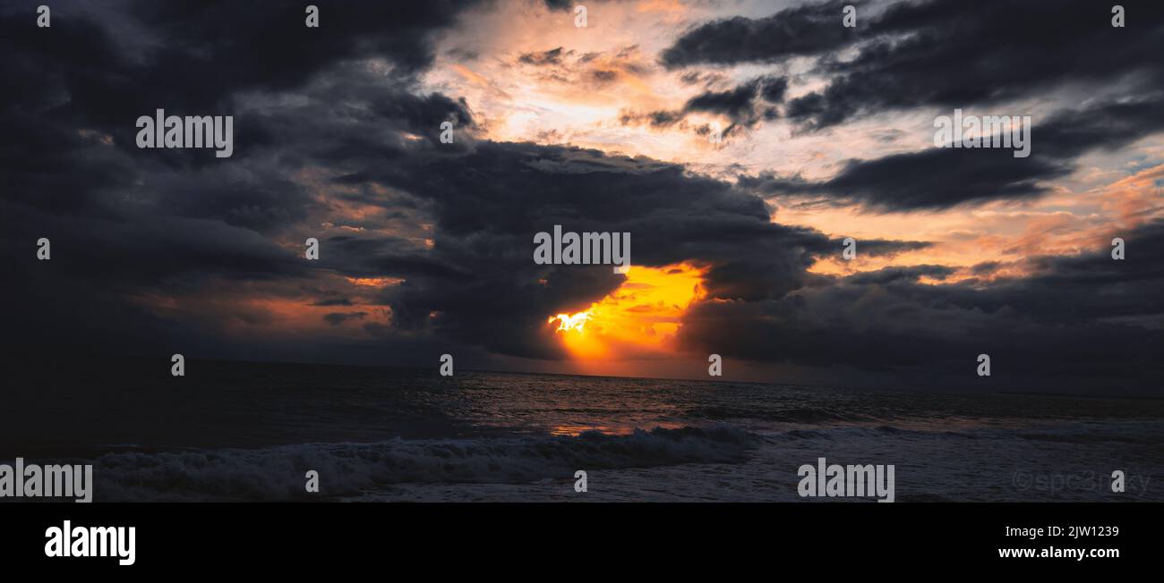 Dramatic sunset in a beach Stock Photo - Alamy