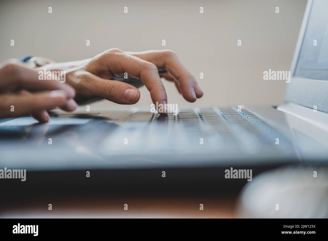 Low angle closeup view of female fingery using and typing on laptop ...