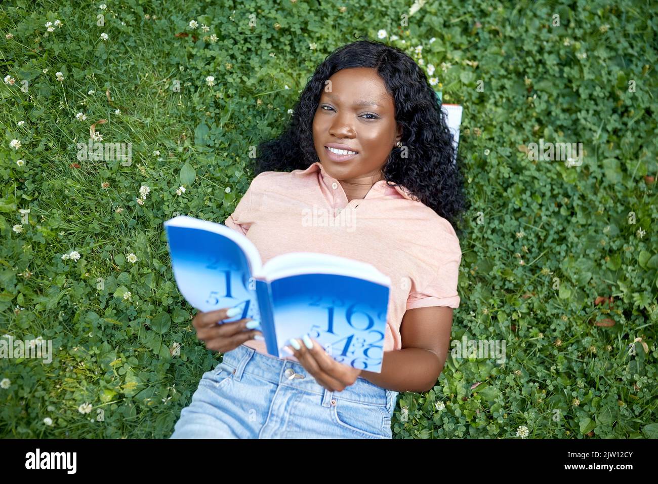 african student girl reading math textbook Stock Photo - Alamy