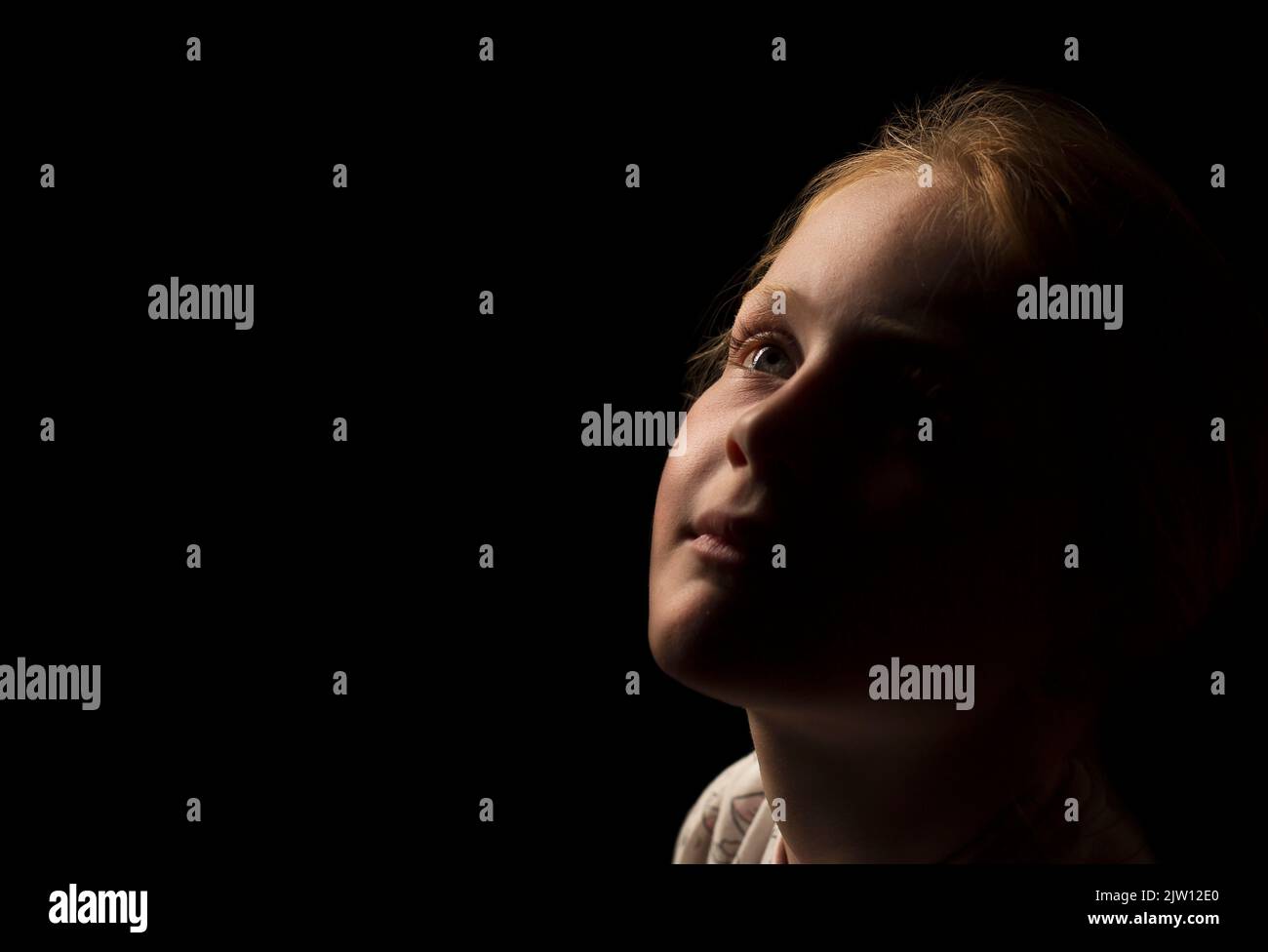 Young Caucasian female with a blank expression looking upwards Stock ...