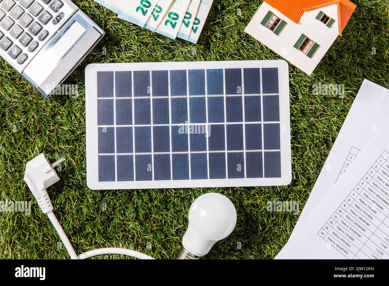 solar battery, bulb, plug, coins and house model Stock Photo - Alamy