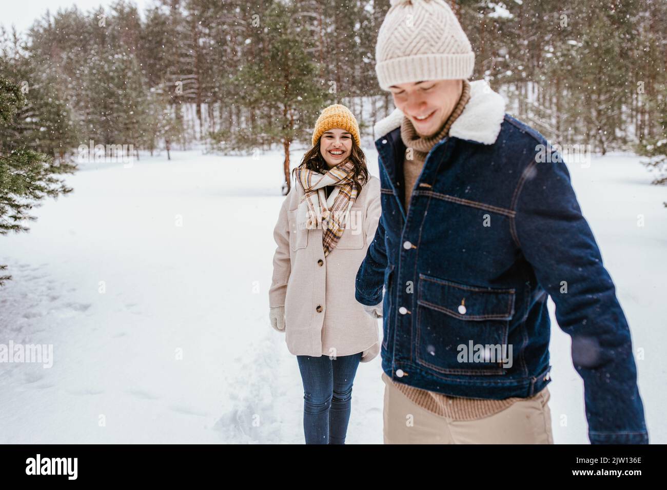 happy smiling couple walking in winter forest Stock Photo - Alamy