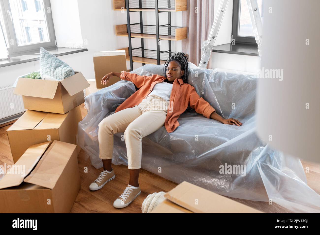 tired woman sleeping on sofa moving to new home Stock Photo - Alamy