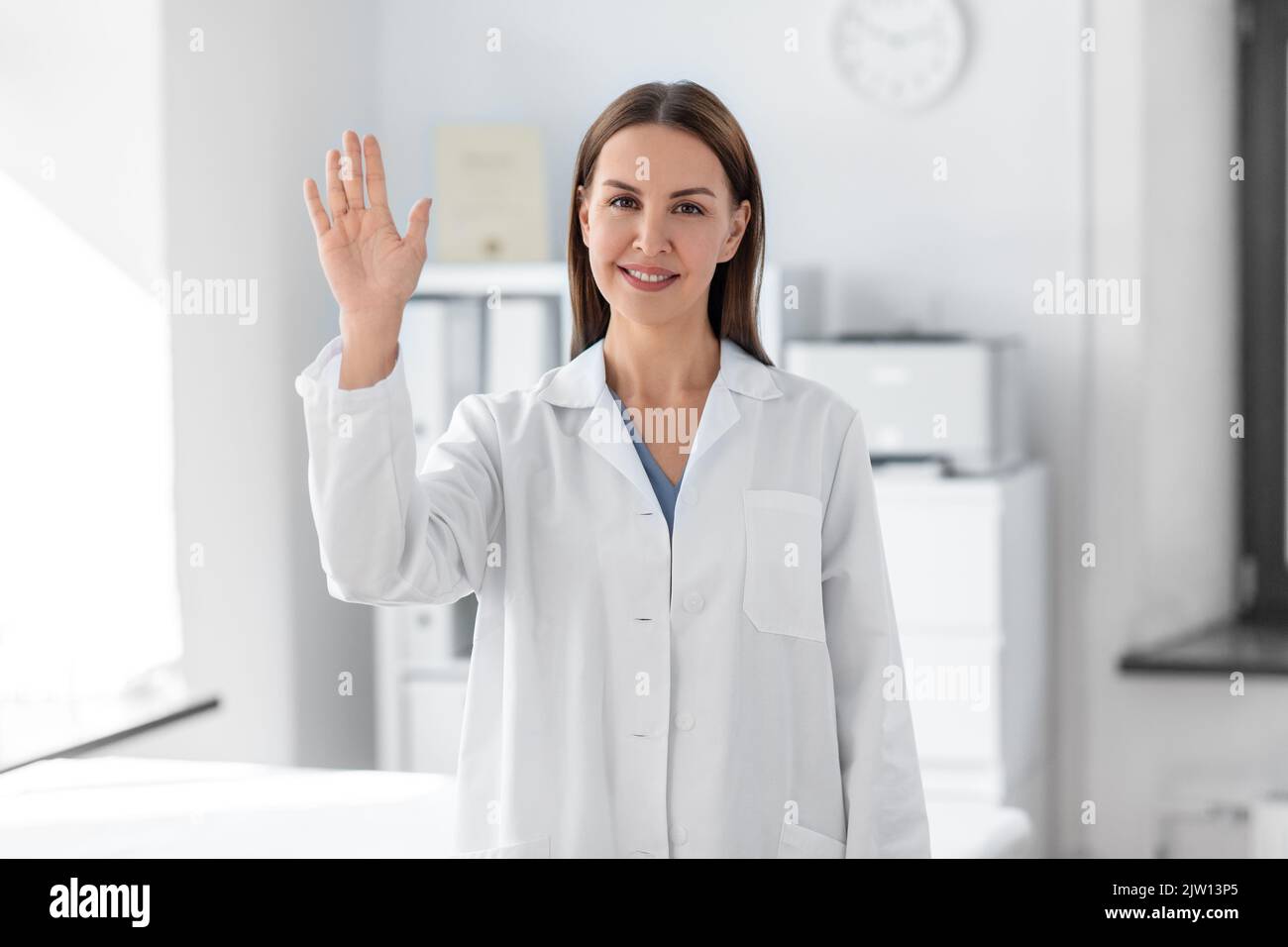 Female doctor waving hand hi-res stock photography and images - Alamy