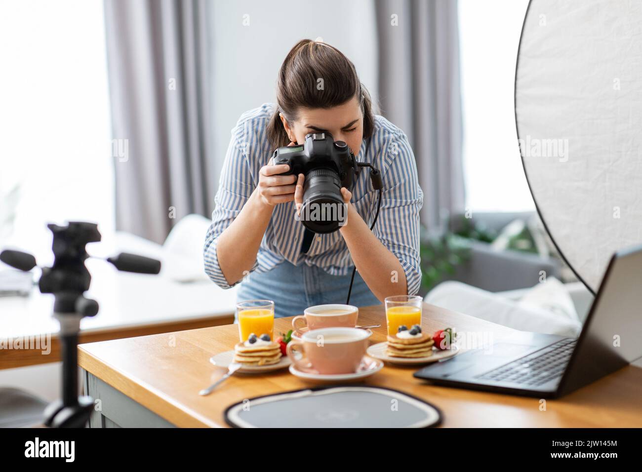 food photographer with camera working in kitchen Stock Photo - Alamy