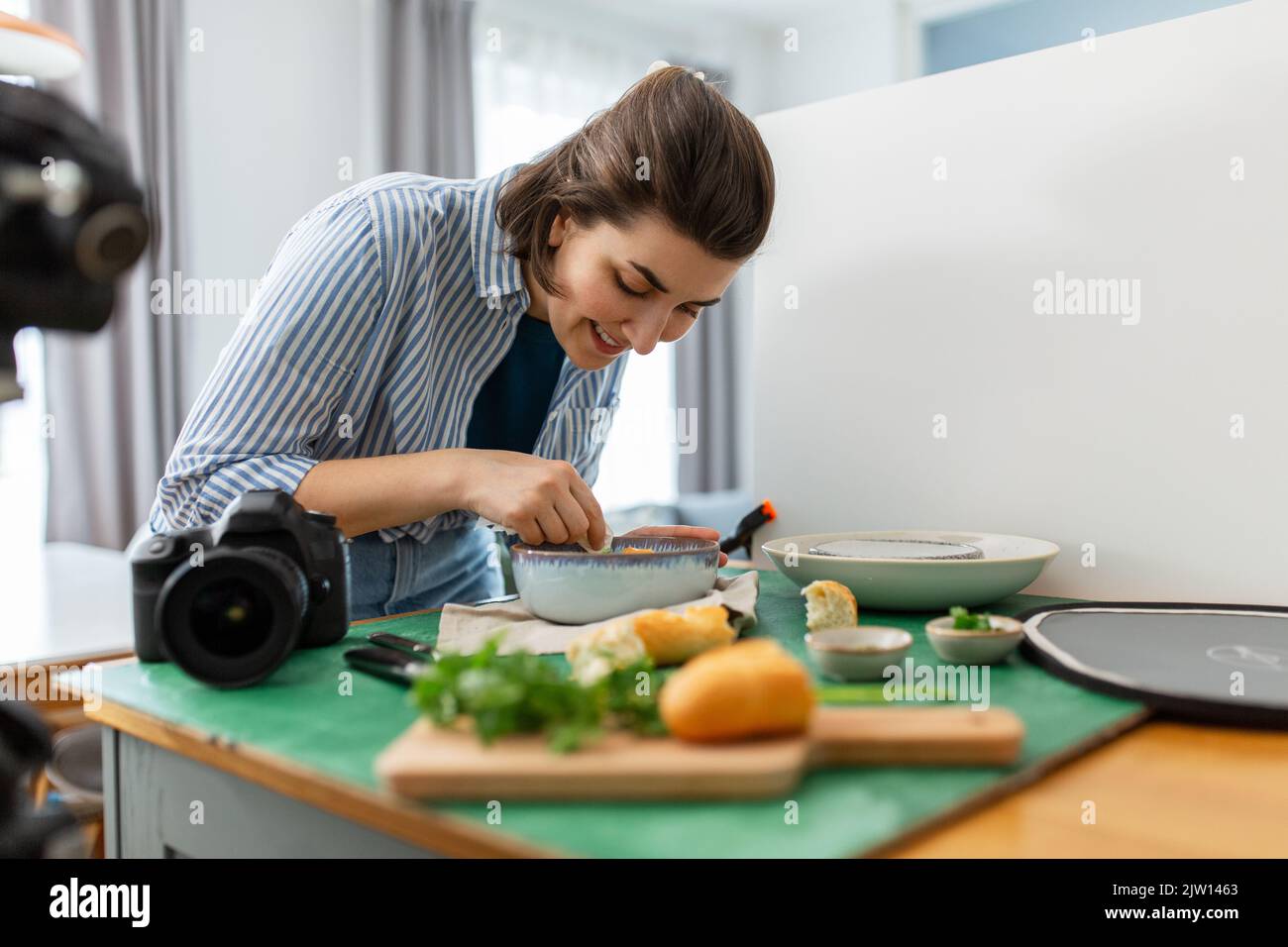 food photographer arranging composition in kitchen Stock Photo - Alamy