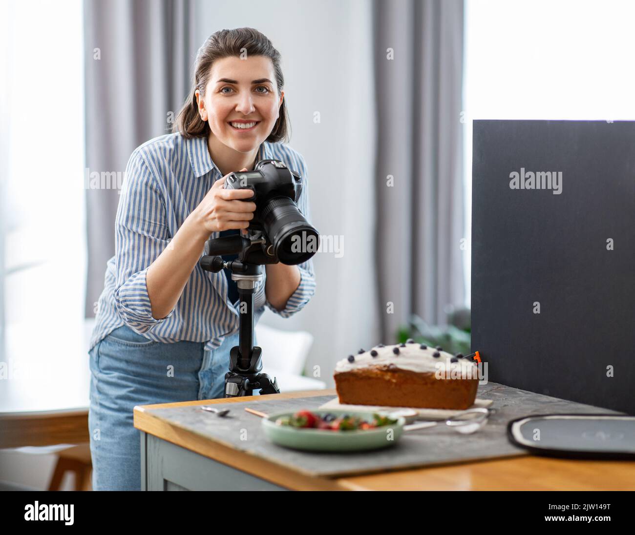food photographer with camera working in kitchen Stock Photo - Alamy