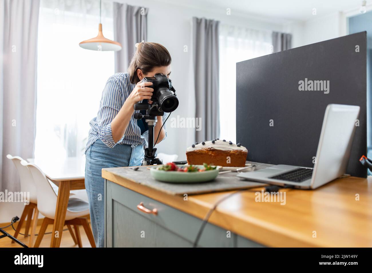 food photographer with camera working in kitchen Stock Photo - Alamy