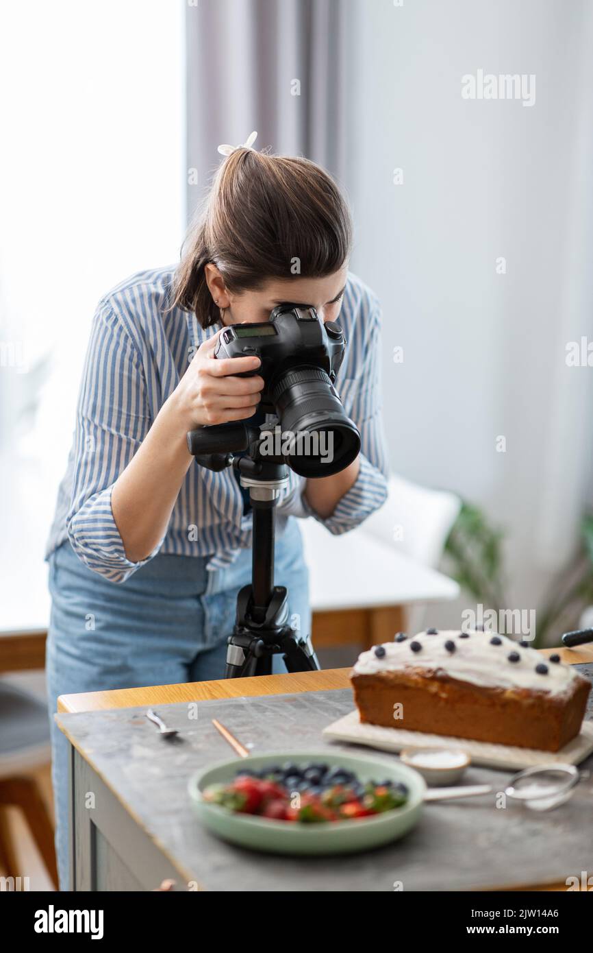 food photographer with camera working in kitchen Stock Photo - Alamy