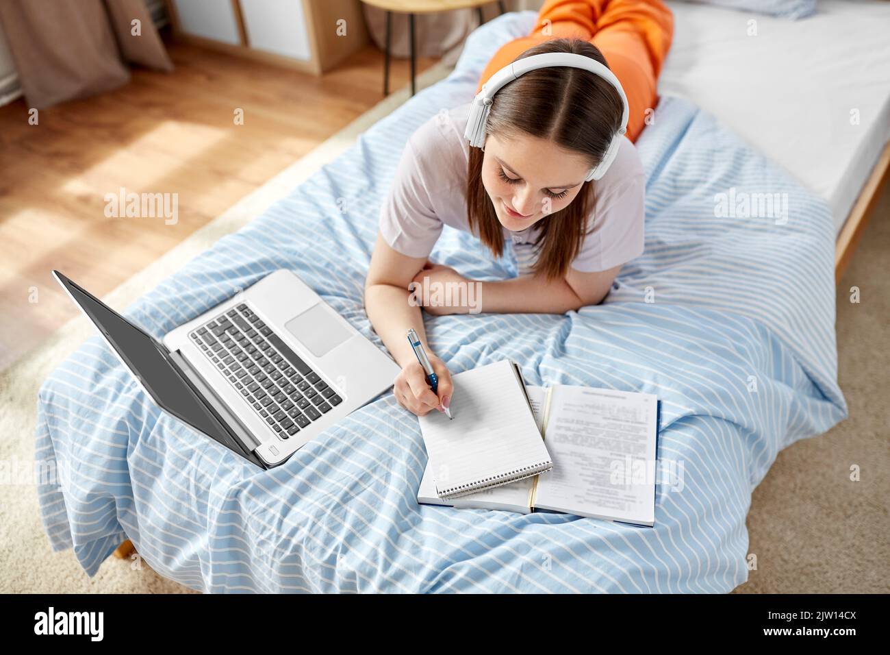 happy student girl in headphones learning at home Stock Photo - Alamy