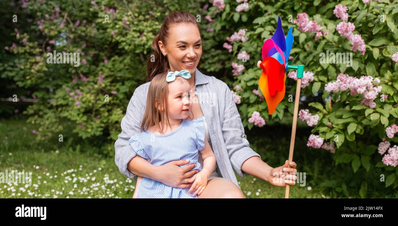 happy mother and daughter with pin wheel at park Stock Photo - Alamy