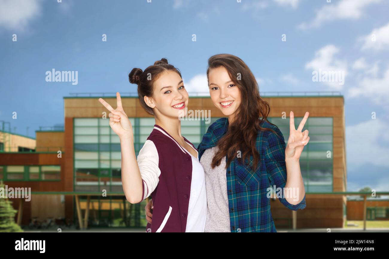 happy pretty teenage girls showing peace hand sign Stock Photo - Alamy