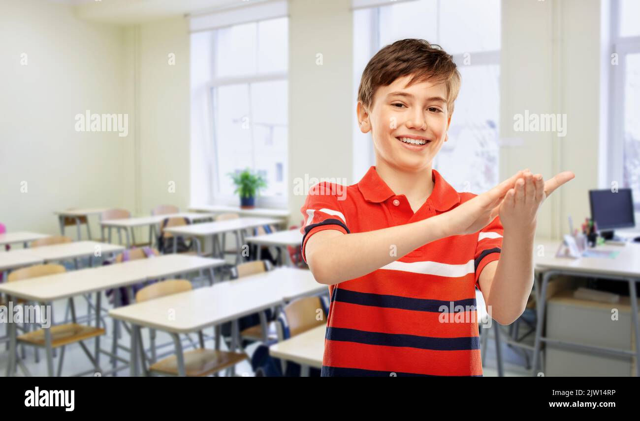 happy smiling student boy applauding at school Stock Photo - Alamy