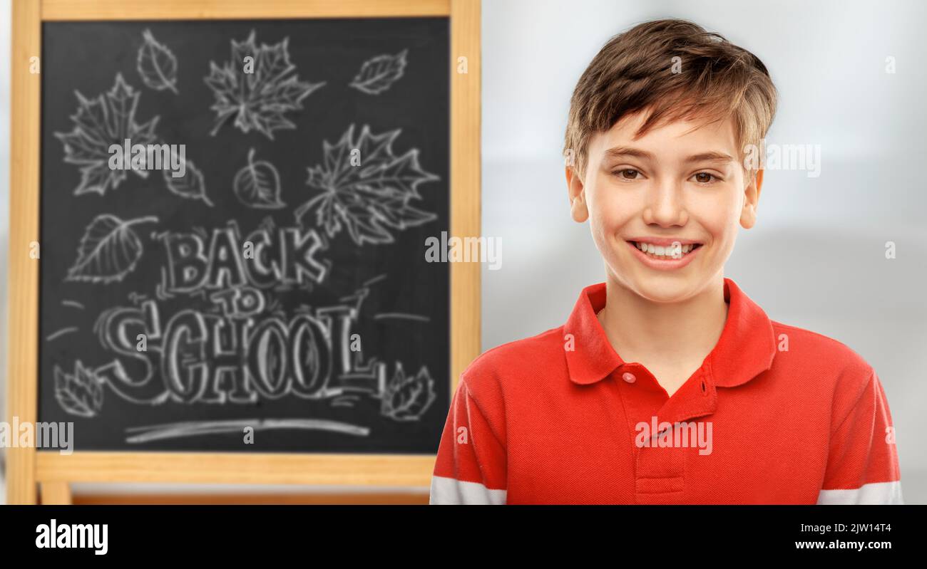 happy smiling student boy over chalkboard Stock Photo - Alamy