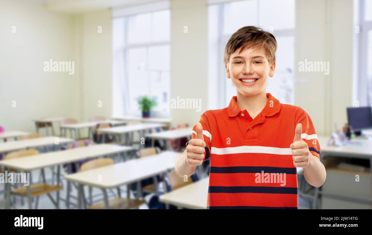 happy student boy showing thumbs up at school Stock Photo - Alamy