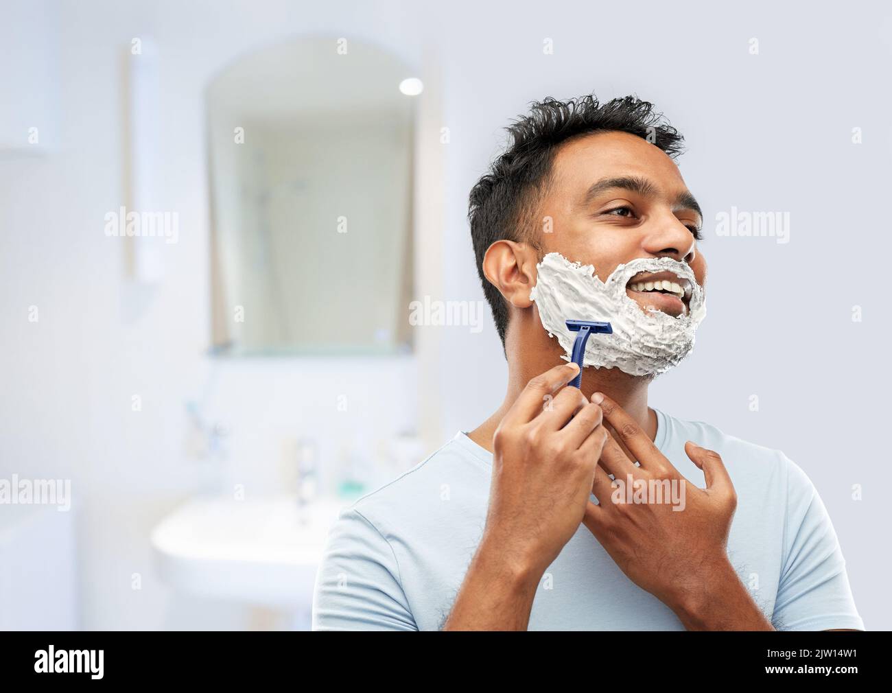 man shaving beard with razor blade in bathroom Stock Photo - Alamy