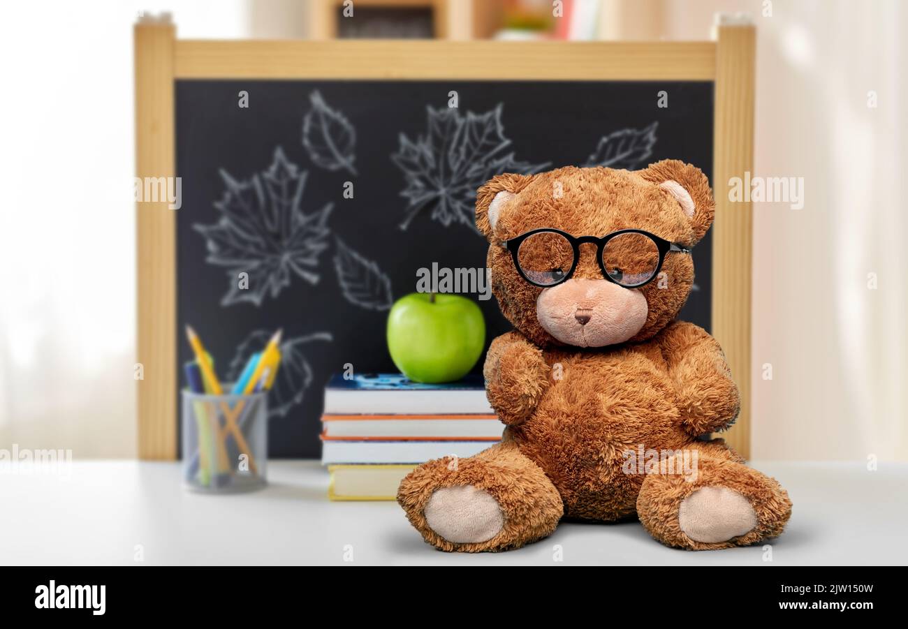 teddy bear in glasses over school chalkboard Stock Photo - Alamy