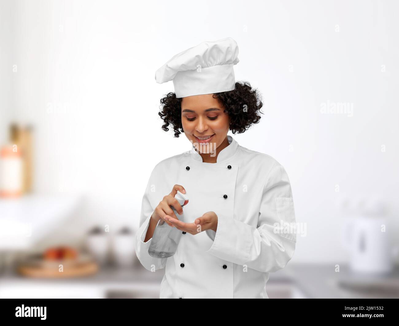 female chef applying hand sanitizer or liquid soap Stock Photo - Alamy