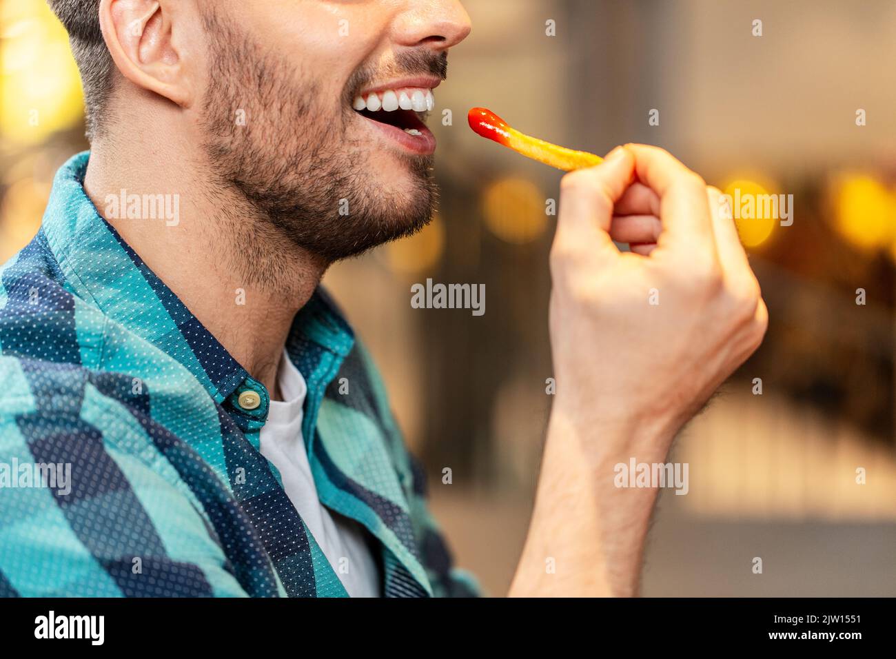 close up of happy man eating french fries Stock Photo - Alamy
