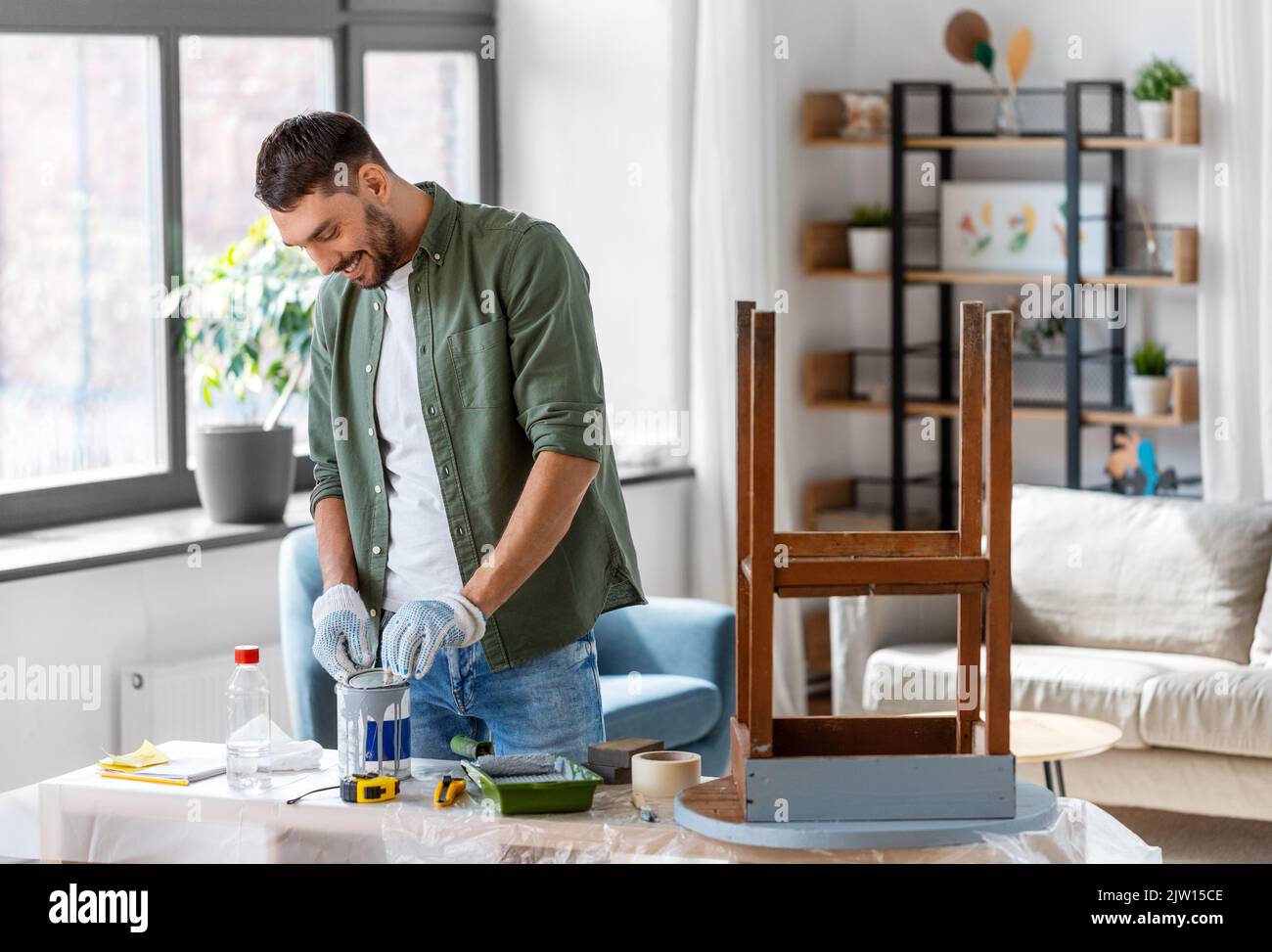 man opening can with grey color at home Stock Photo - Alamy