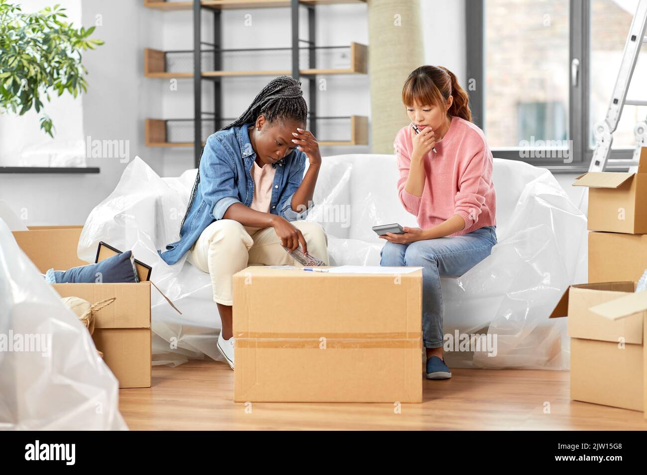women moving to new home and counting money Stock Photo - Alamy