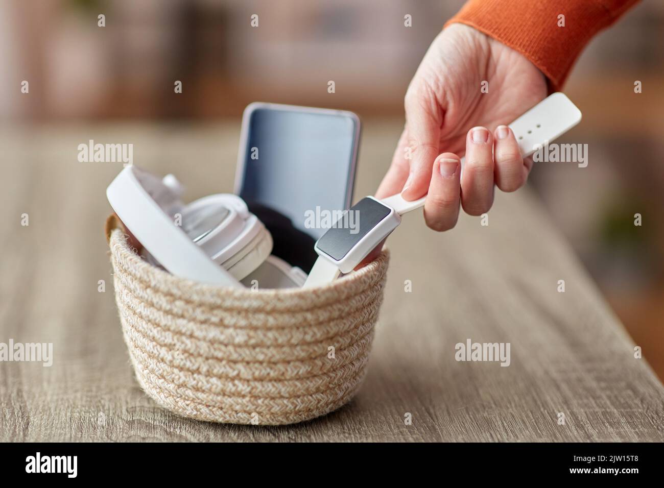 hand holding smart watch and gadgets in basket Stock Photo - Alamy