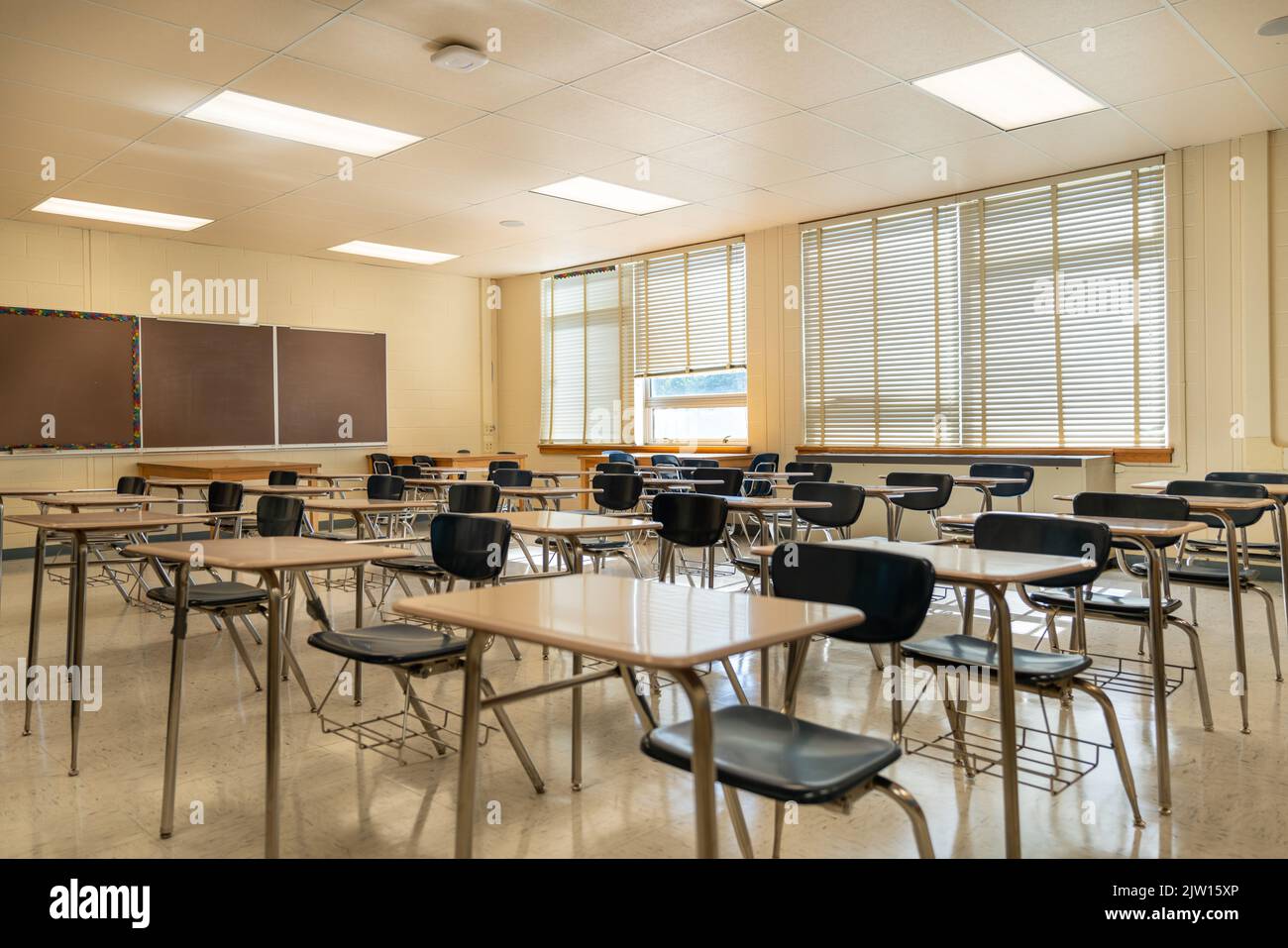 Example of an empty nondescript US High School Classroom with desks ...