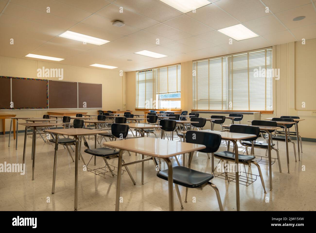 Example of an empty nondescript US High School Classroom with desks ...