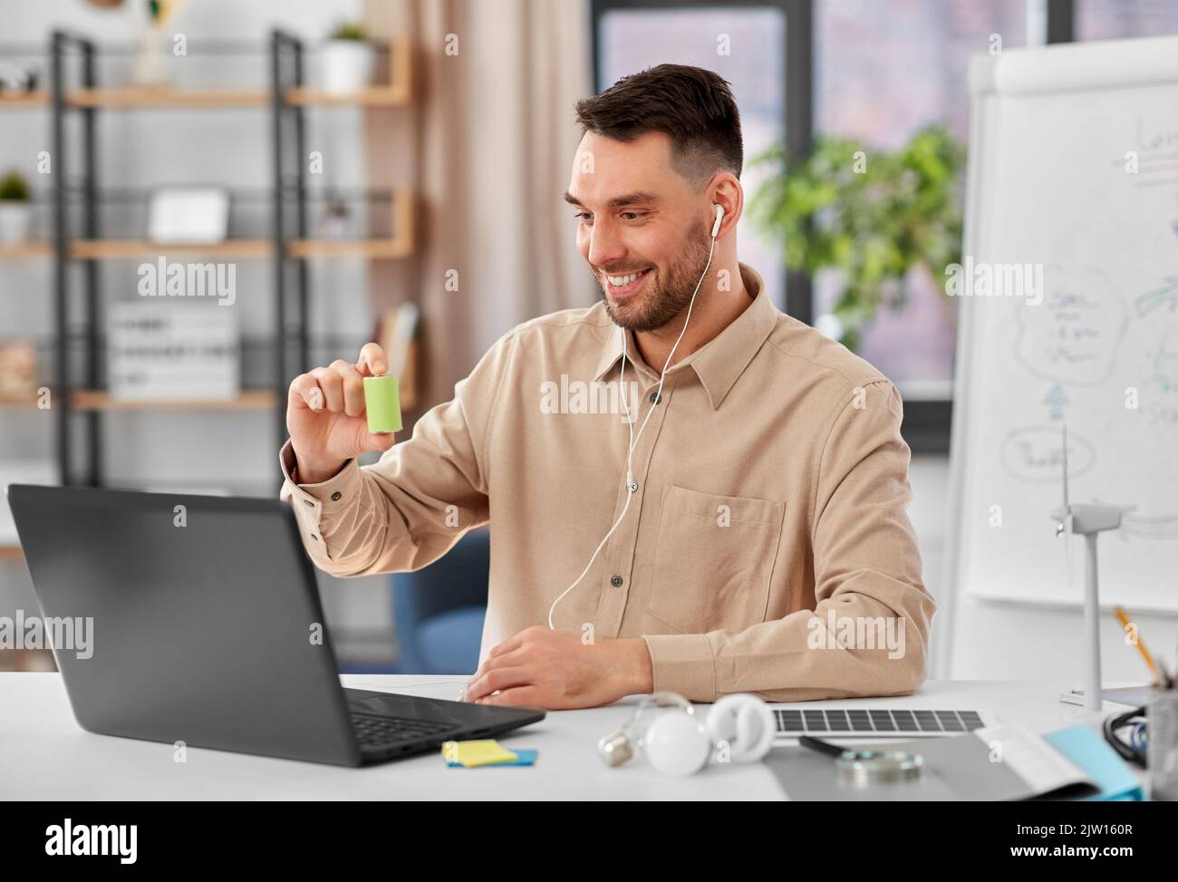 male teacher with laptop and battery at home Stock Photo - Alamy