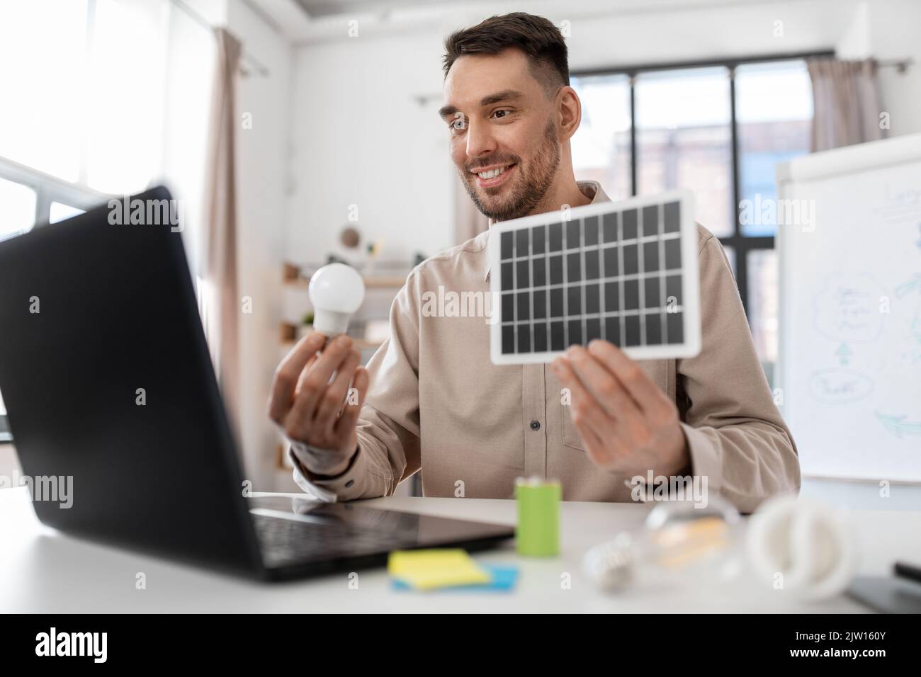 male teacher with laptop and solar battery at home Stock Photo - Alamy