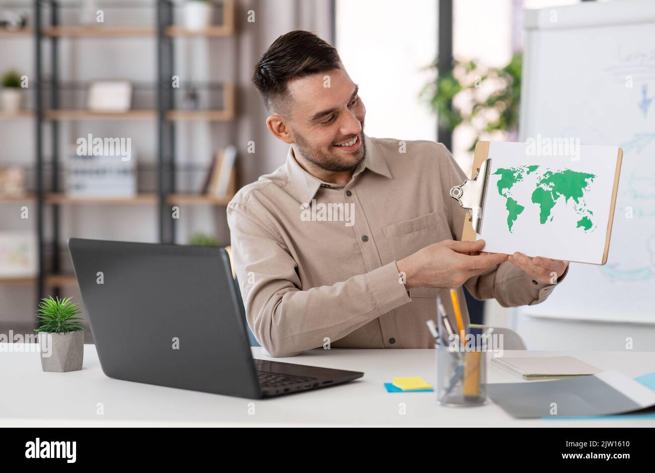 teacher with world map having online class at home Stock Photo - Alamy