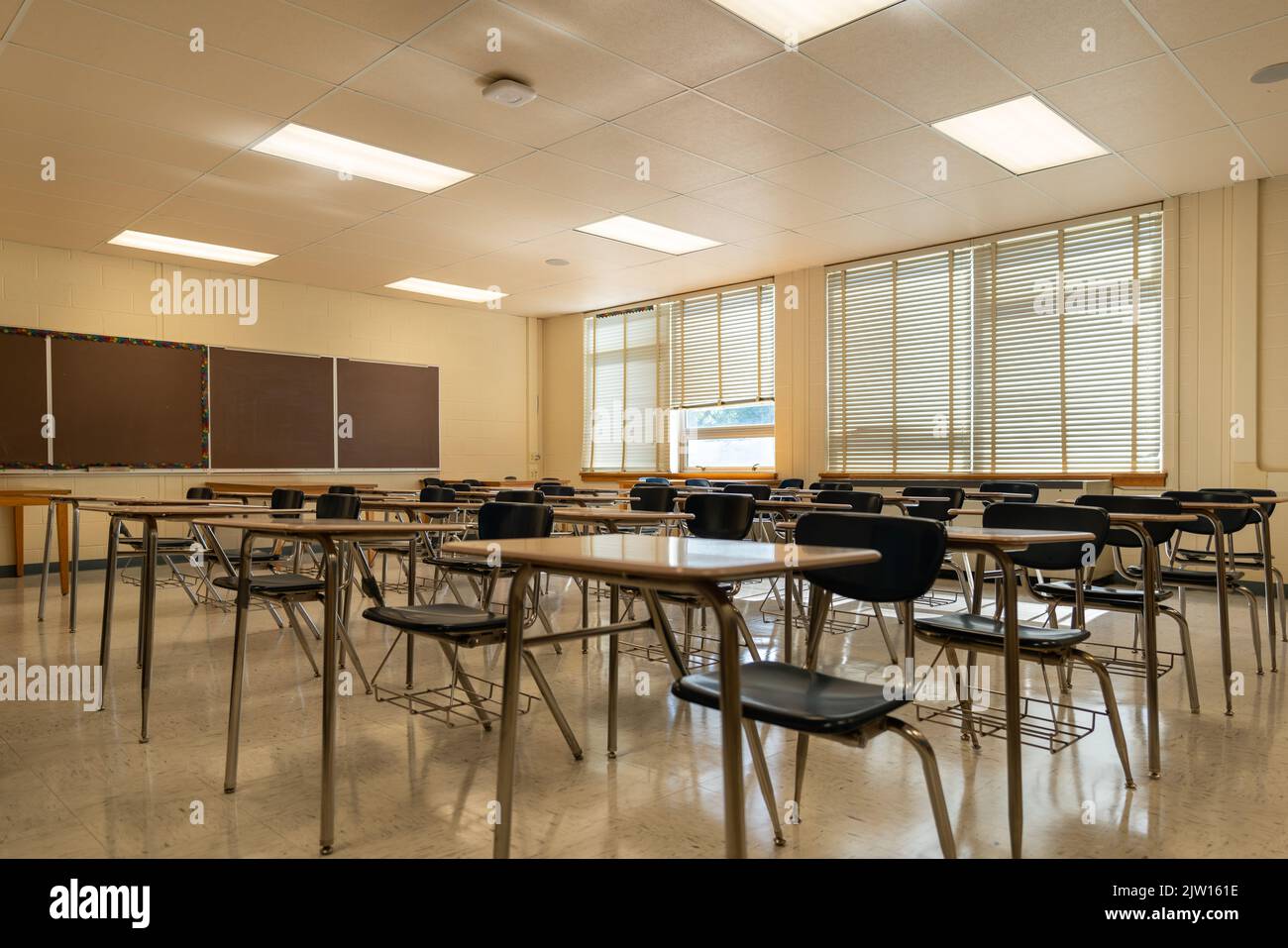 Example of an empty nondescript US High School Classroom with desks ...