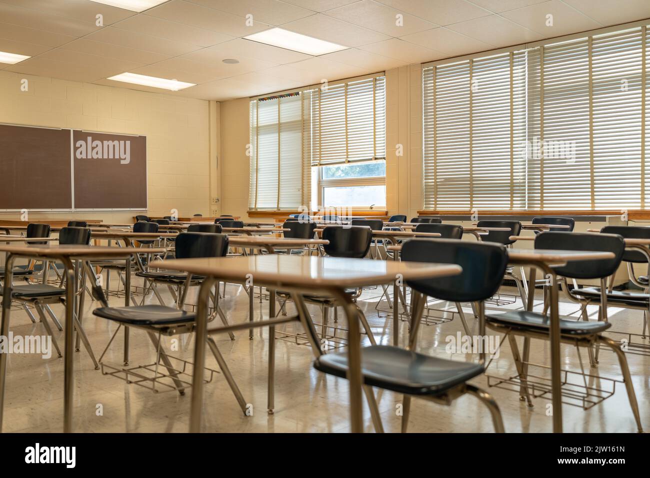 Example of an empty nondescript US High School Classroom with desks ...