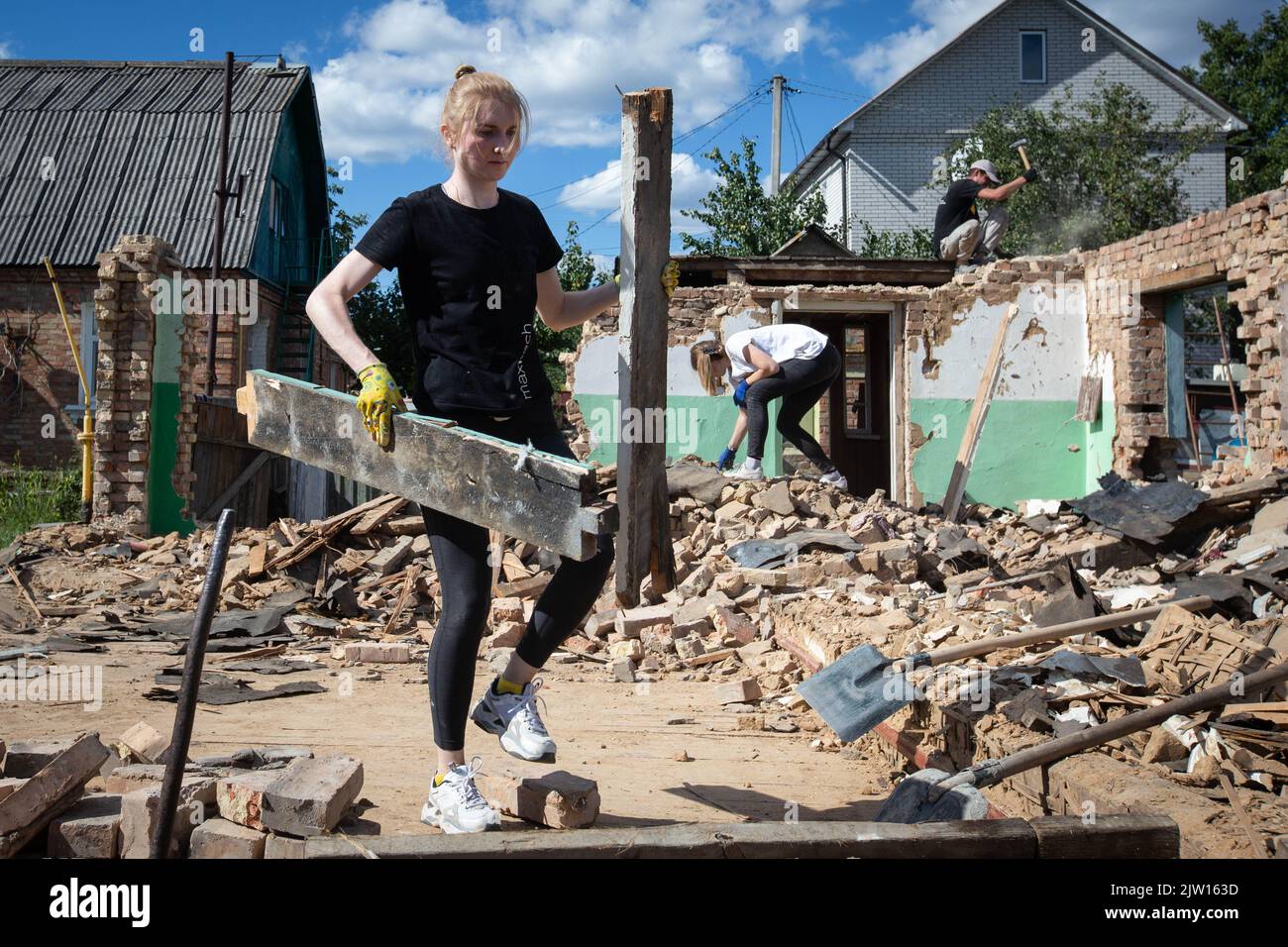 Bucha, Ukraine. 01st Sep, 2022. A volunteer clears the rubble of a ...