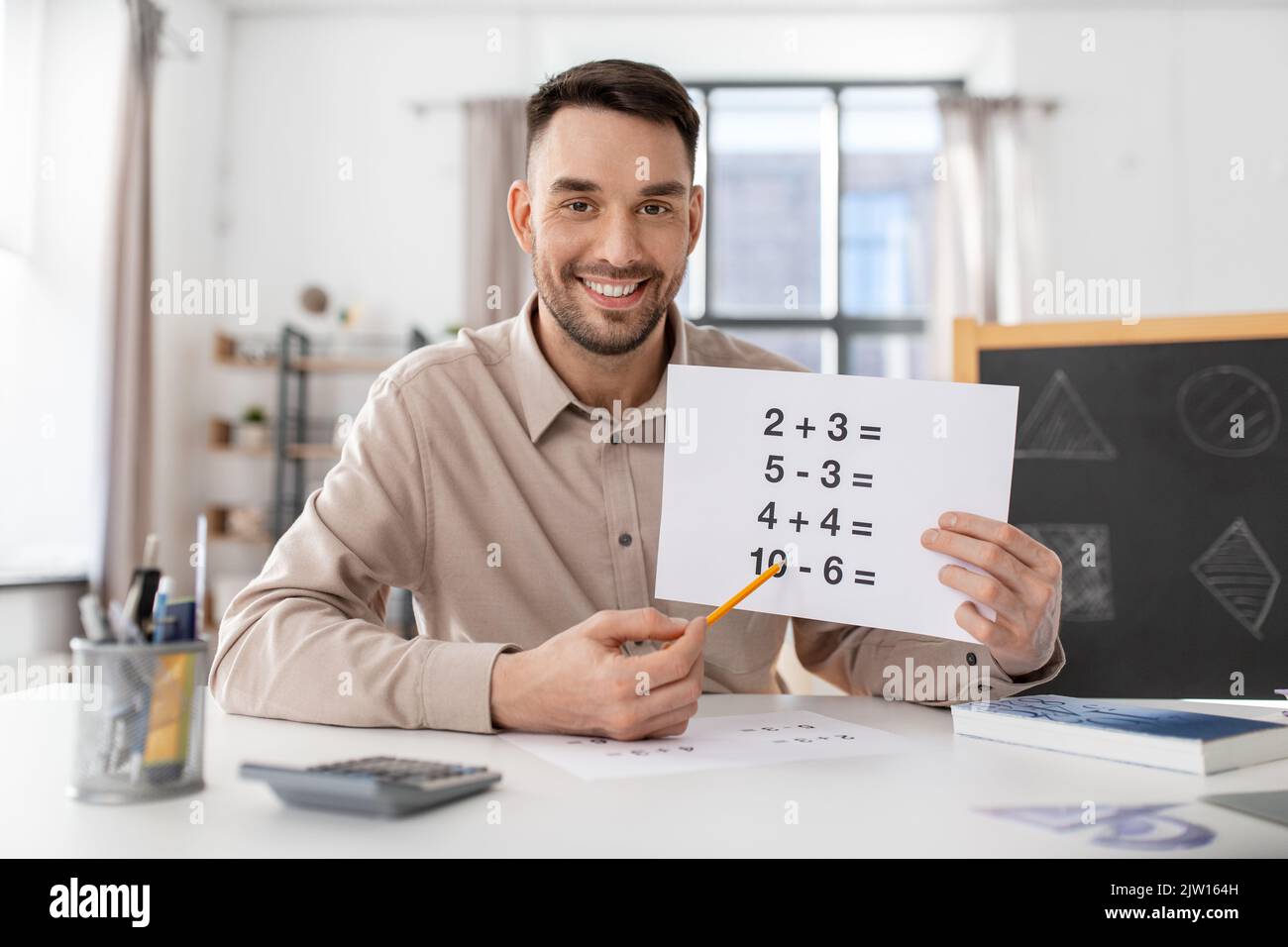 Young male teacher elementary hi-res stock photography and images - Alamy