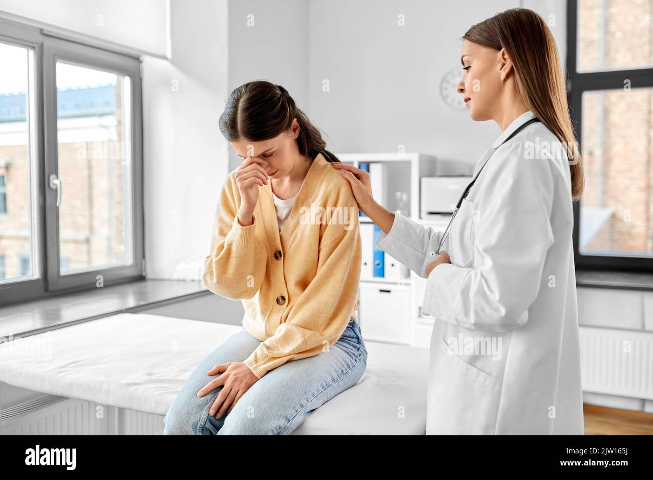 female doctor comforting sad woman at hospital Stock Photo - Alamy