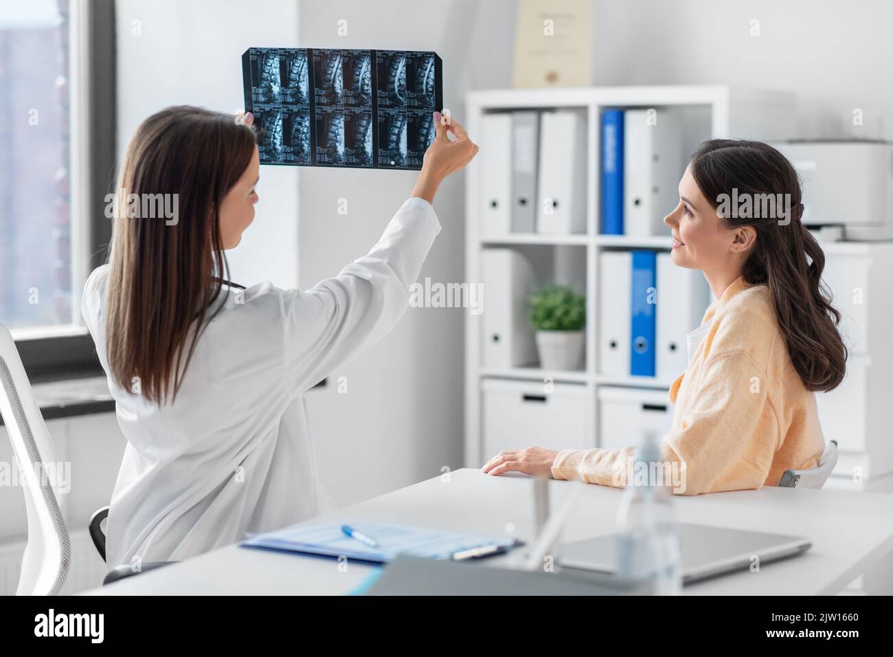 doctor showing x-ray image to woman at hospital Stock Photo - Alamy