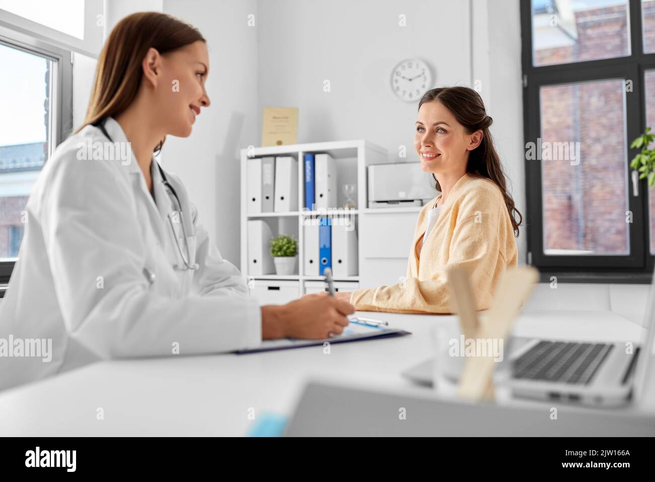 female doctor and woman patient meeting at clinic Stock Photo - Alamy