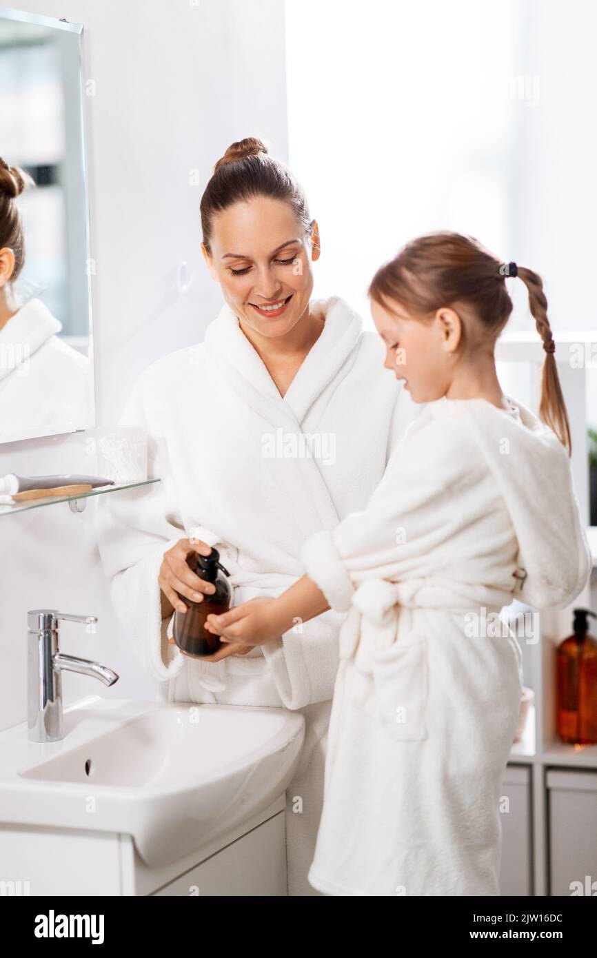 mother and daughter with liquid soap in bathroom Stock Photo - Alamy