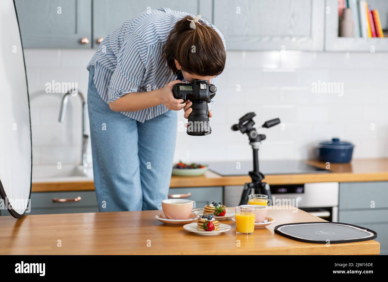 food photographer with camera working in kitchen Stock Photo - Alamy