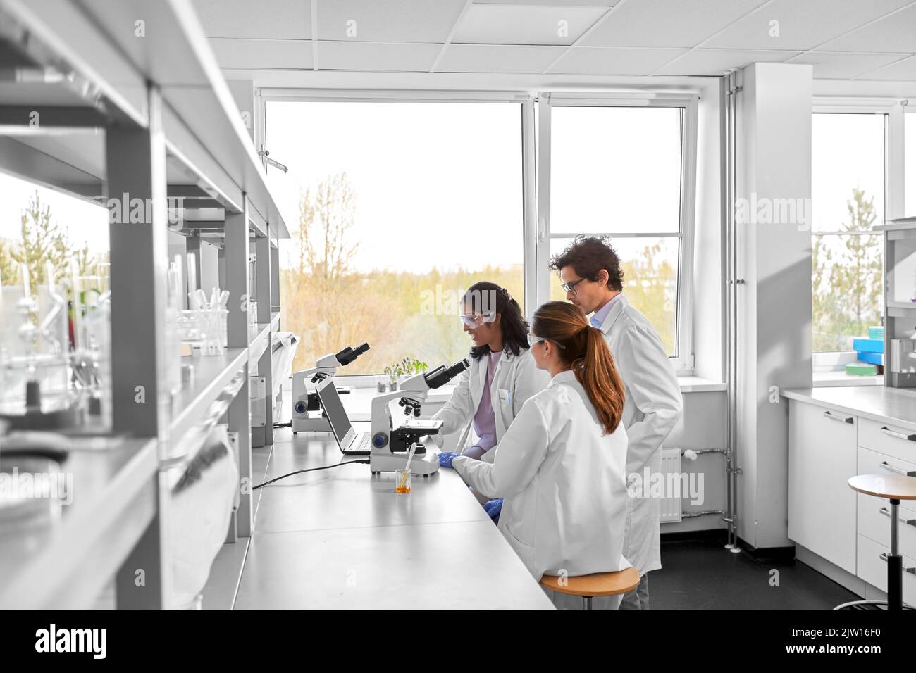 Science team working microscopes hi-res stock photography and images ...