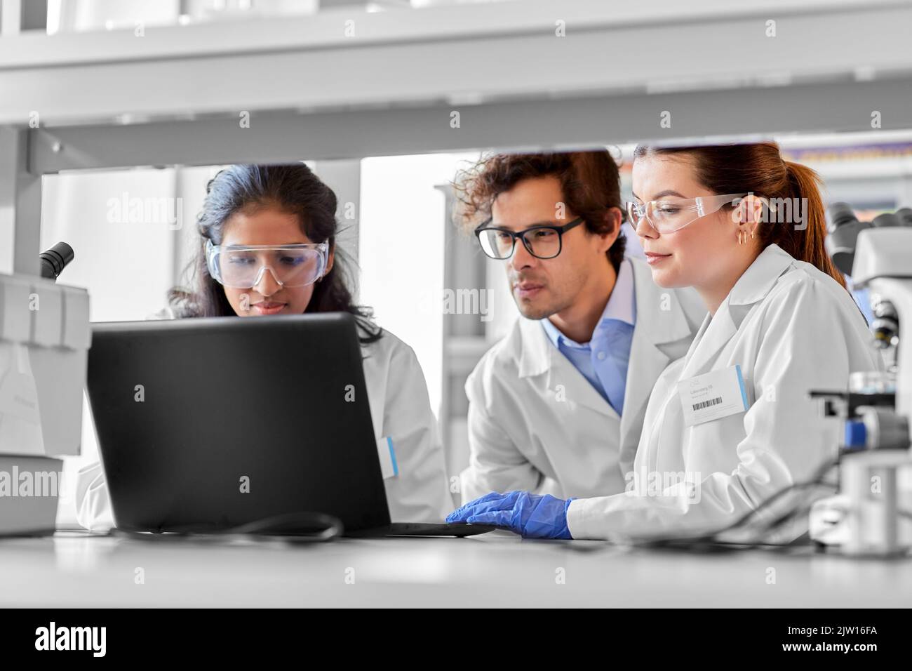 scientists with laptop working in laboratory Stock Photo - Alamy