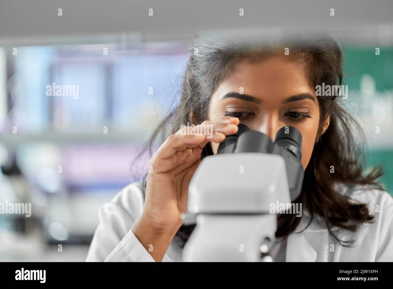 scientist with microscope working in laboratory Stock Photo - Alamy