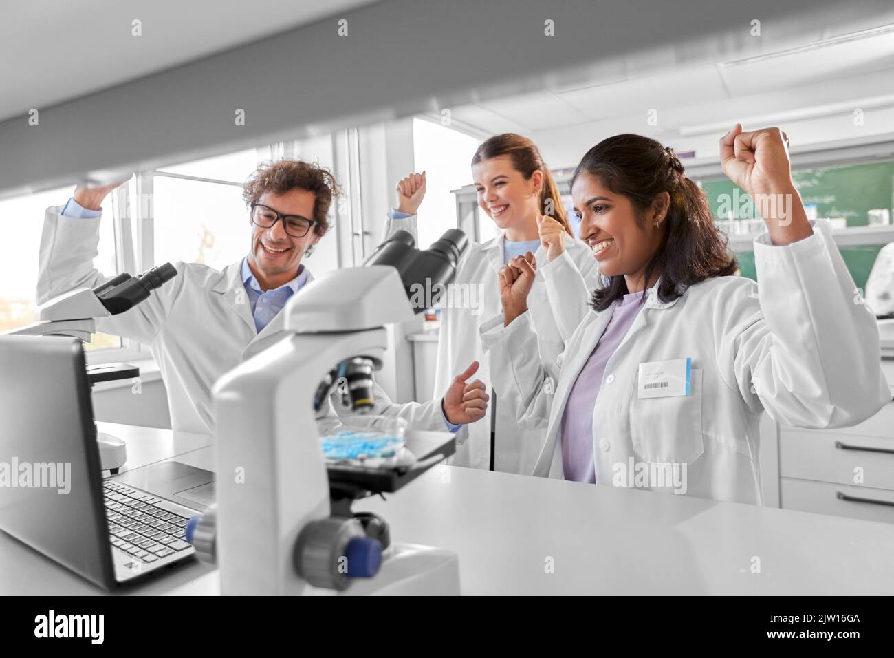 happy group of scientists working in laboratory Stock Photo - Alamy